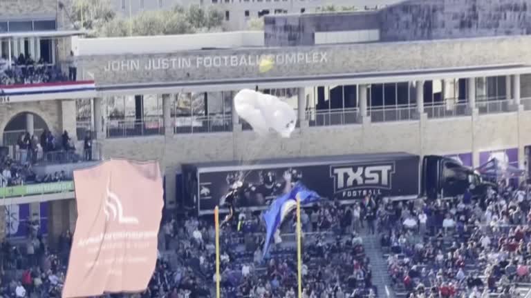American paratrooper gets tangled in net during college football bowl