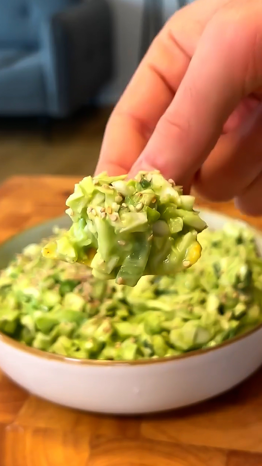 Tossing vegan cabbage salad with avocado sauce