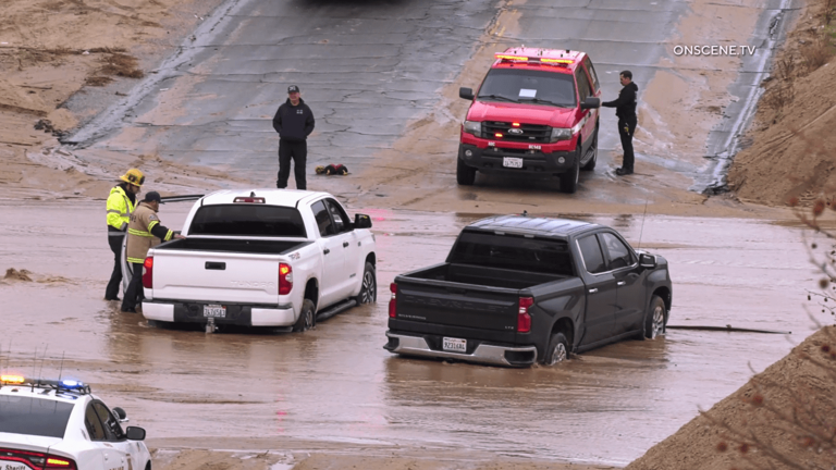 Child carried to safety after vehicles stuck in Southern California ...
