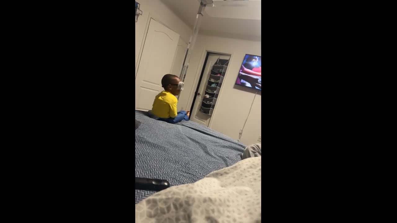Baby makes funny Minion face while watching TV in Florida, USA