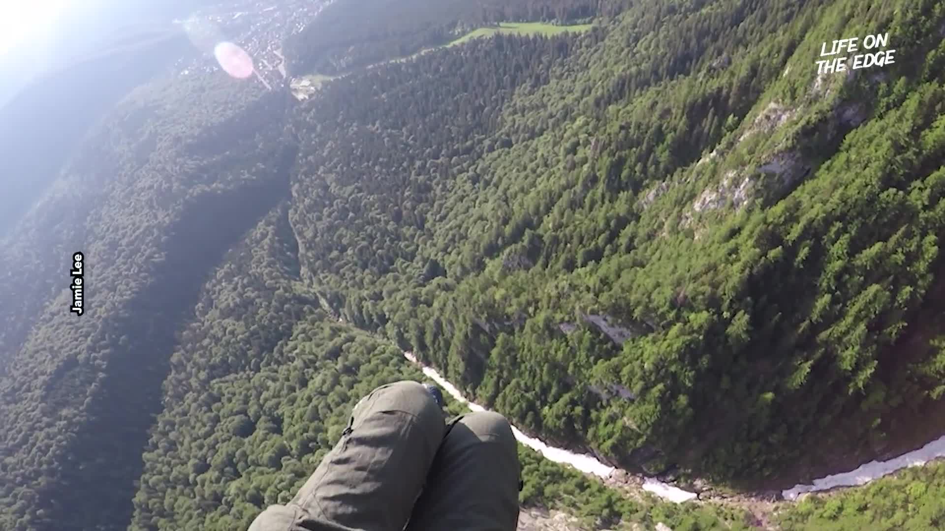 Paraglider skims feet above the ground