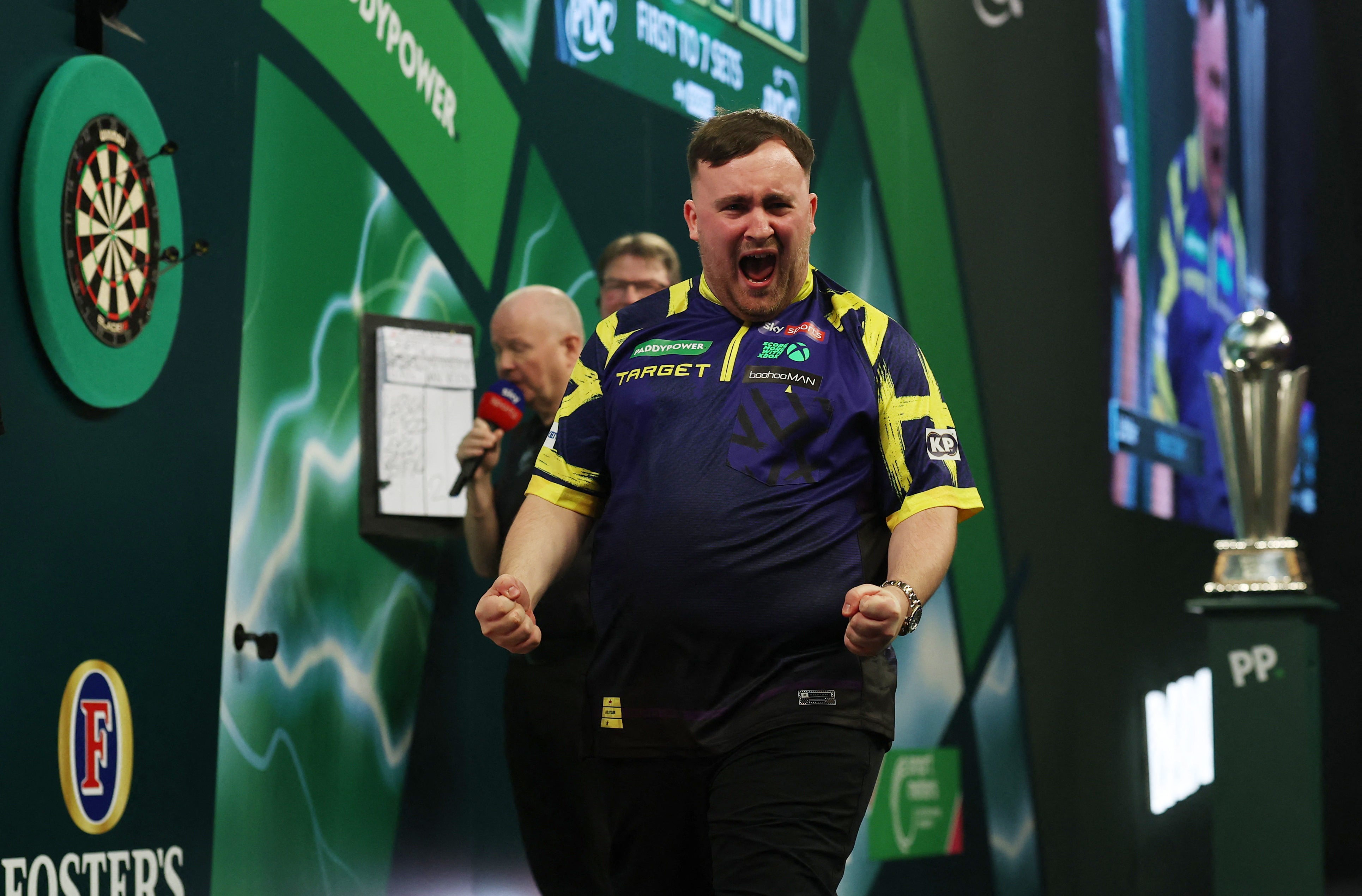 Littler routs Van Veen to win back-to-back World Darts Championships