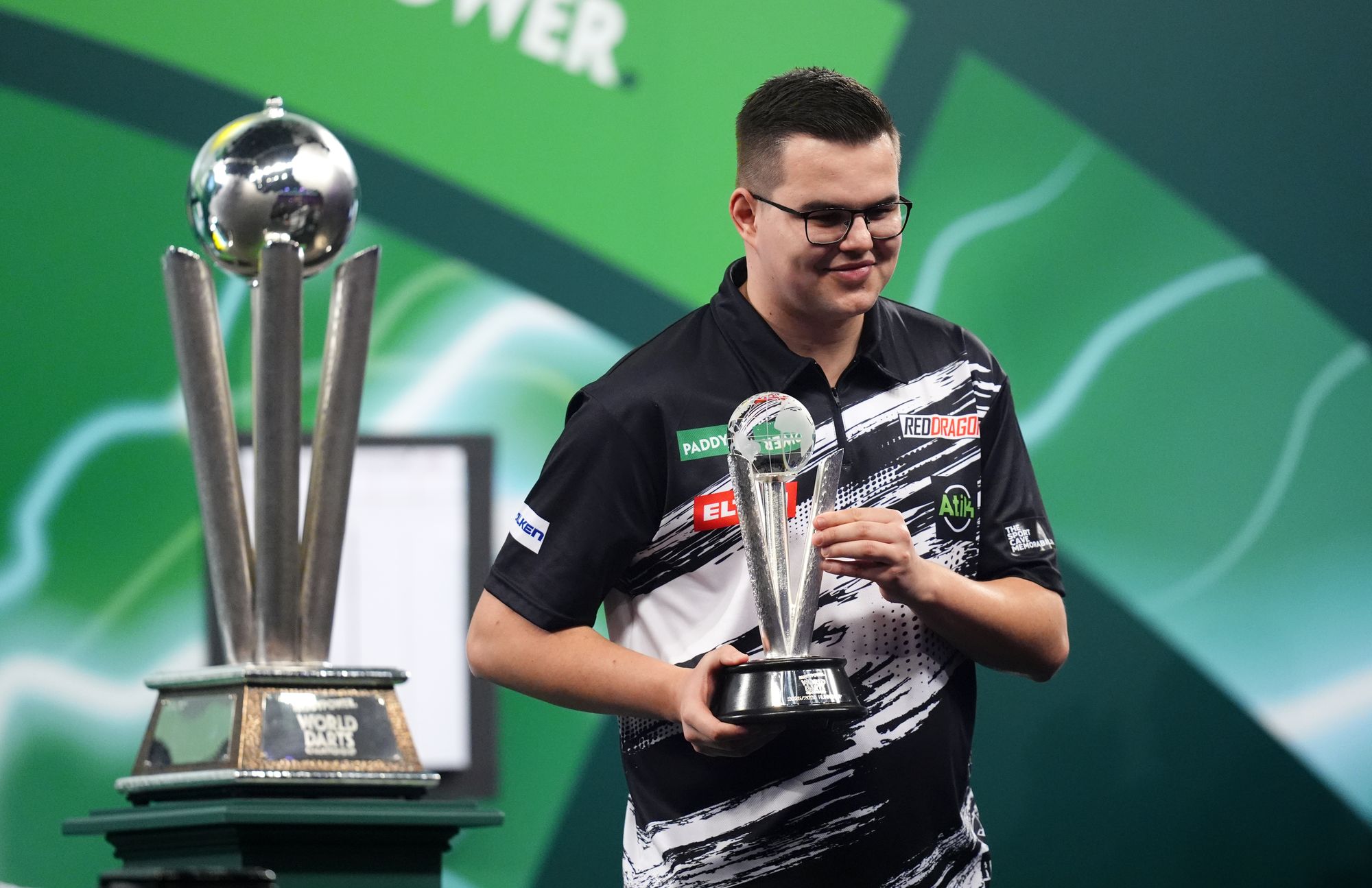 Littler routs Van Veen to win back-to-back World Darts Championships