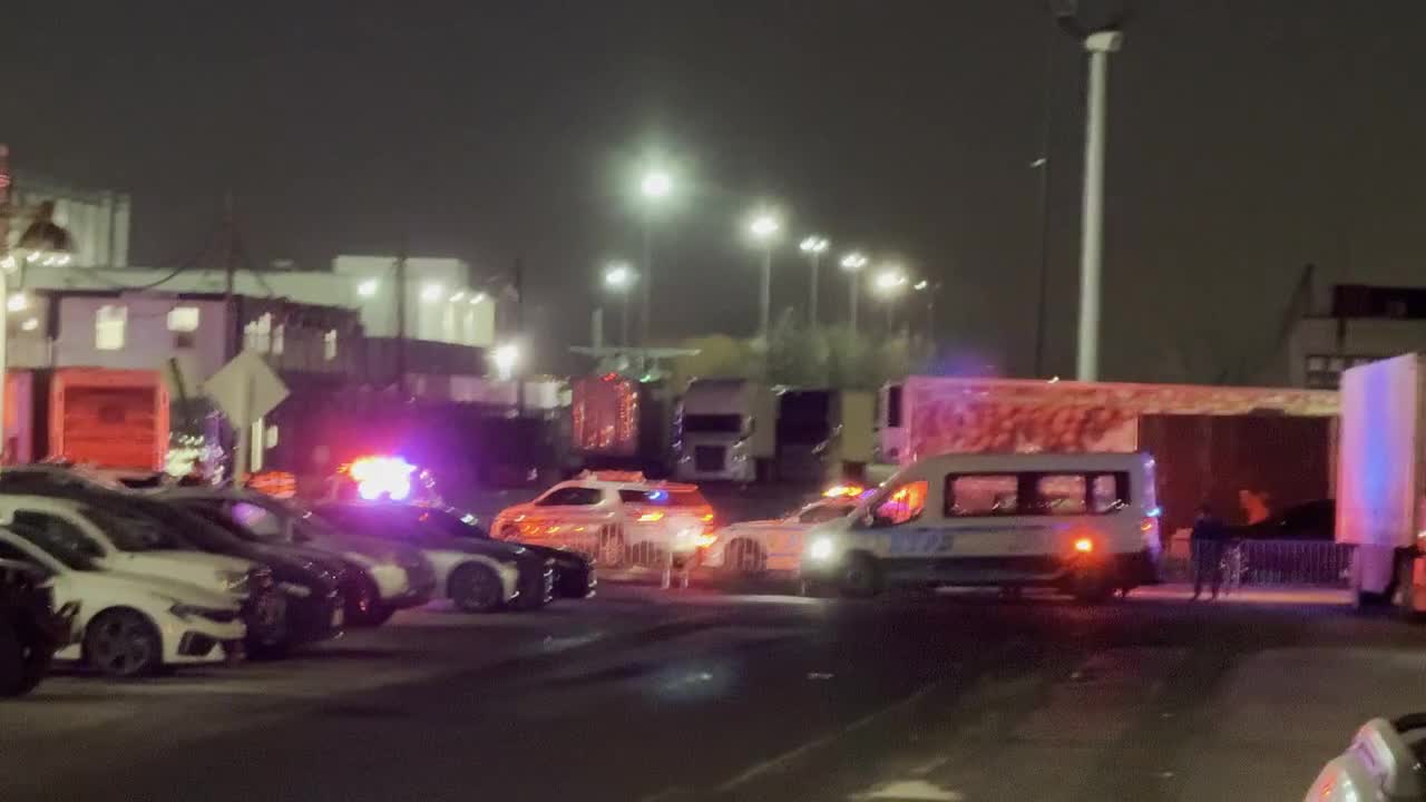 Police vehicles with lights flashing wait outside the Metropolitan ...