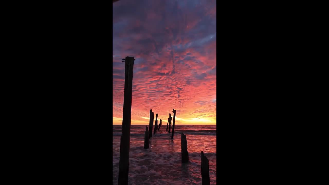 Stunning sunset over the remains of Redington Long Pier, Florida, USA