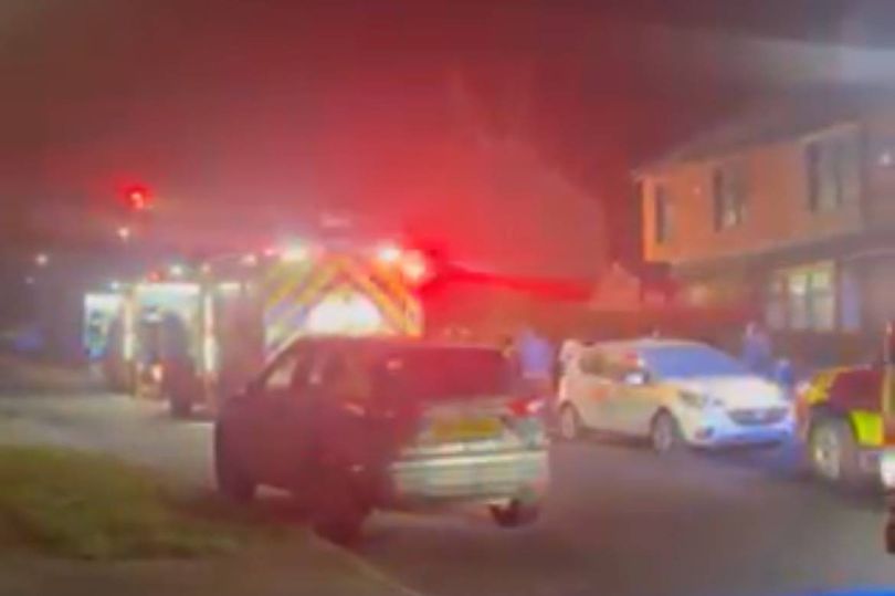 Neighbours kick down door and drag woman from burning house