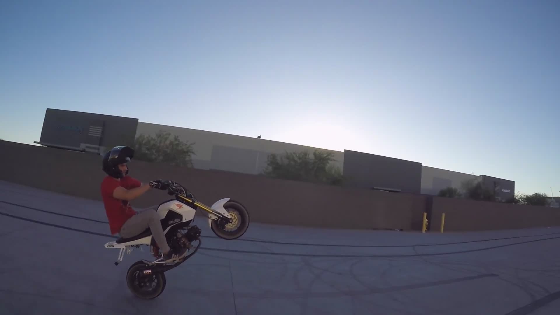 Gear changing while maintaining wheelie balance technique