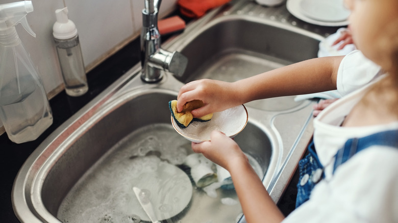 If your dishes still feel greasy after hand washing, here's why