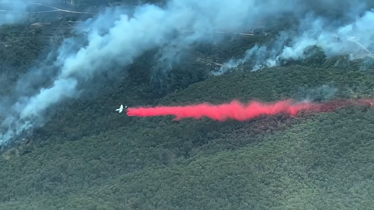 Aerial view of large bushfires and firefighter efforts in Australia