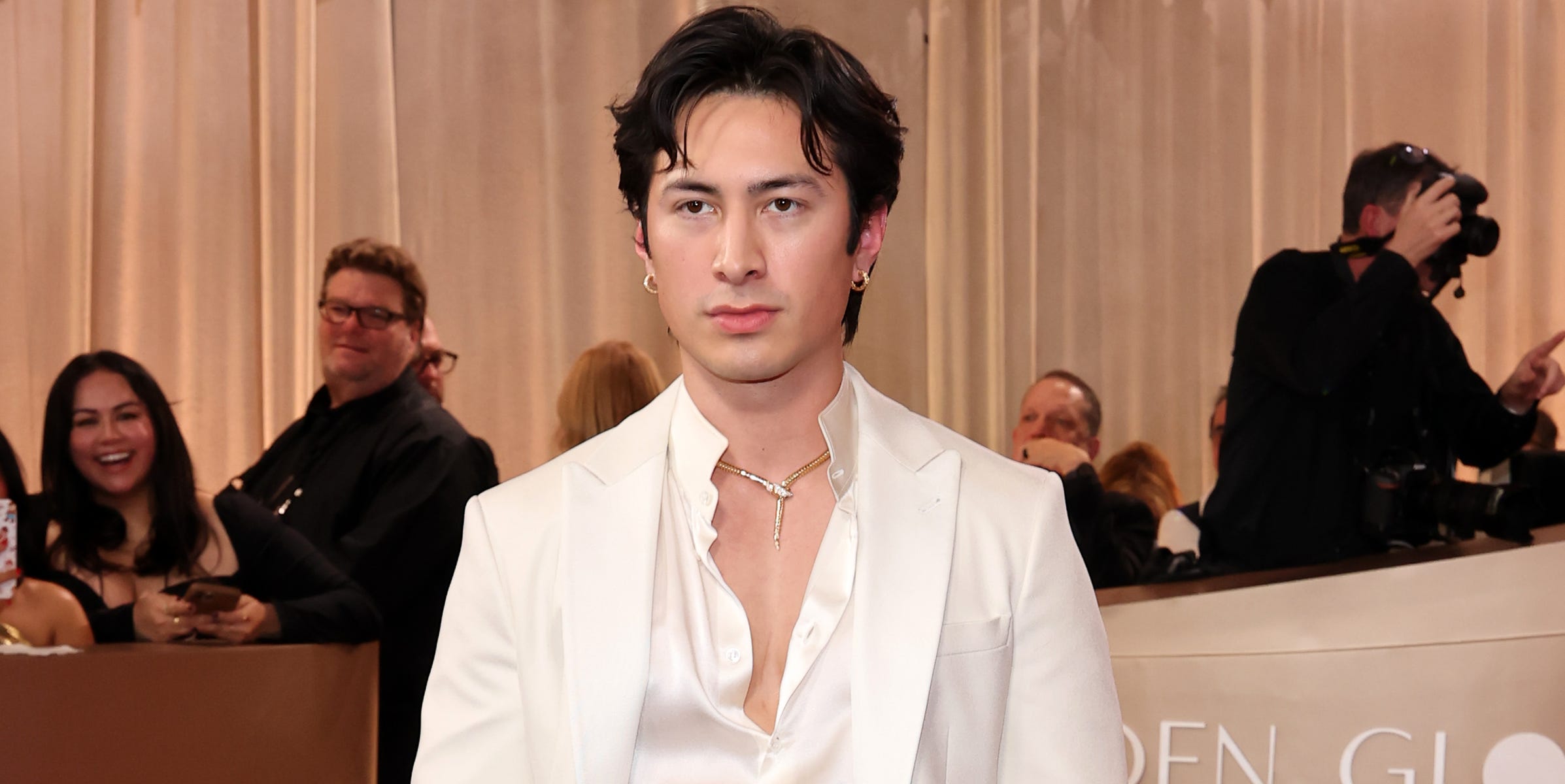 Hudson Williams unbuttons his top few buttons on the Golden Globes red ...