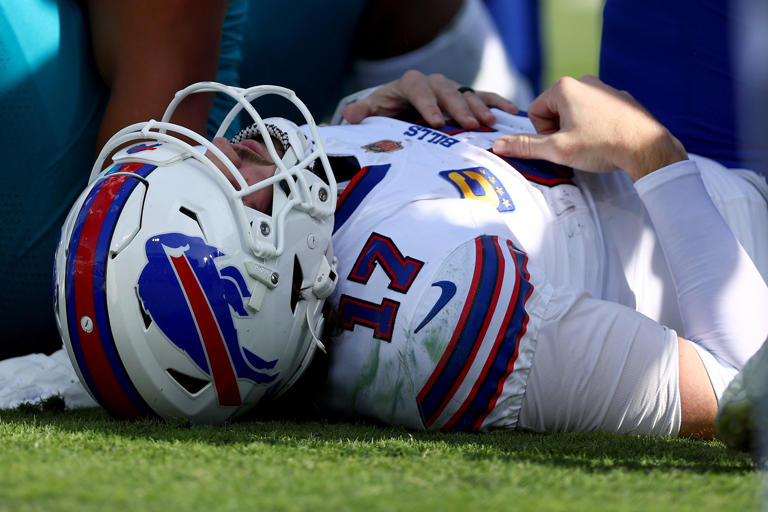 Josh Allen injuries: Bills QB checked for concussion, holds hand in ...
