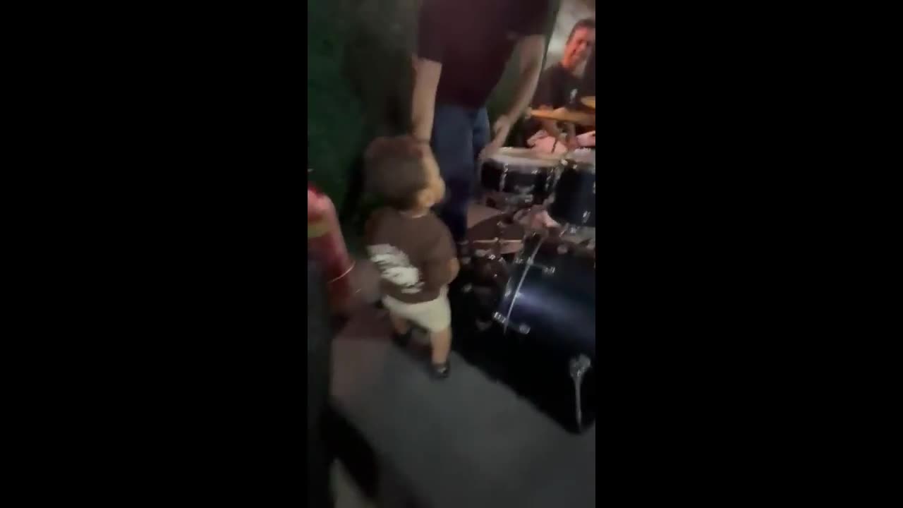 Young boy dances and drums in restaurant in Brazil