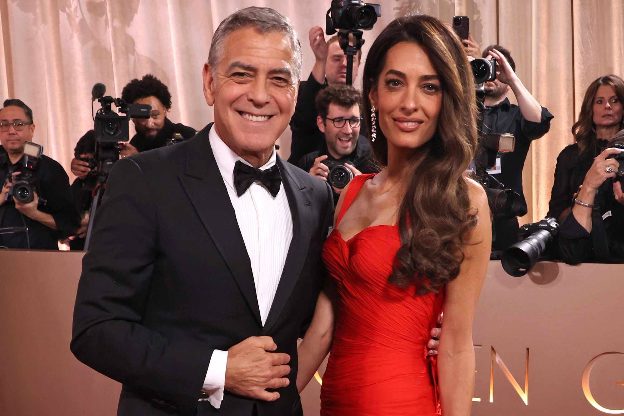 Amal Clooney is radiant in red hot gown alongside George Clooney for ...
