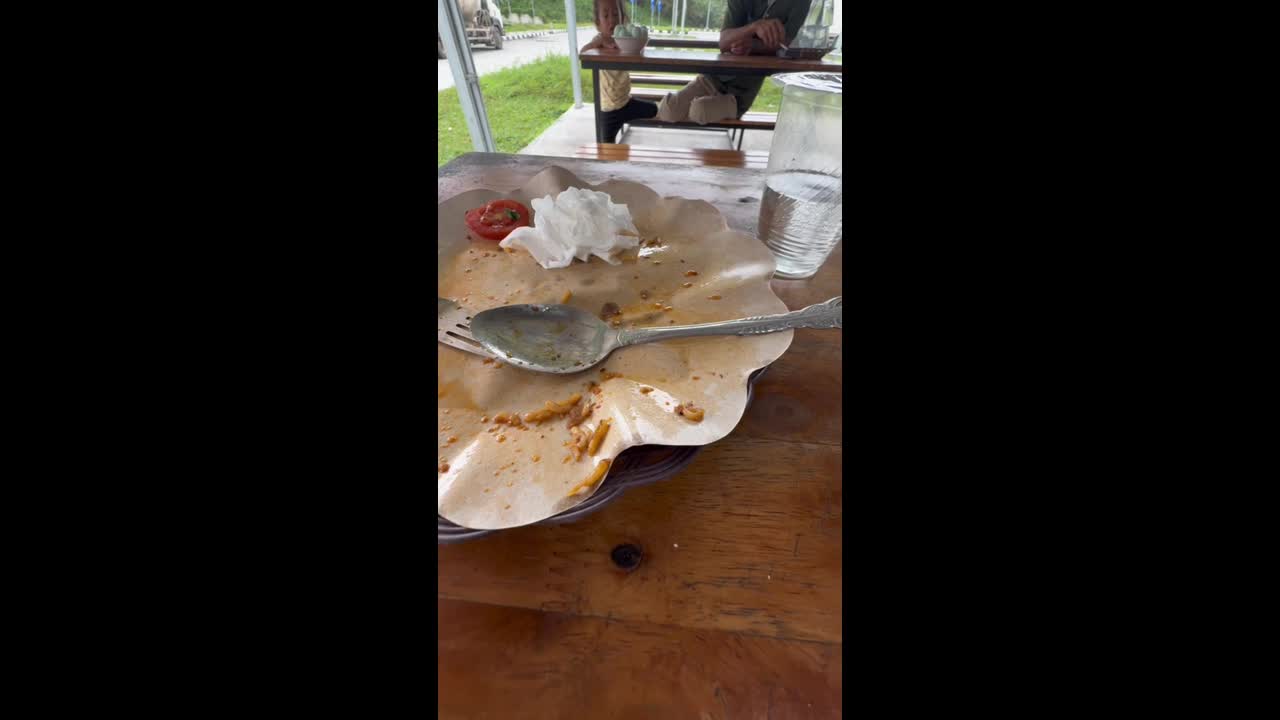 Cat naps inside a slipper after a meal at a resort restaurant in Riau ...