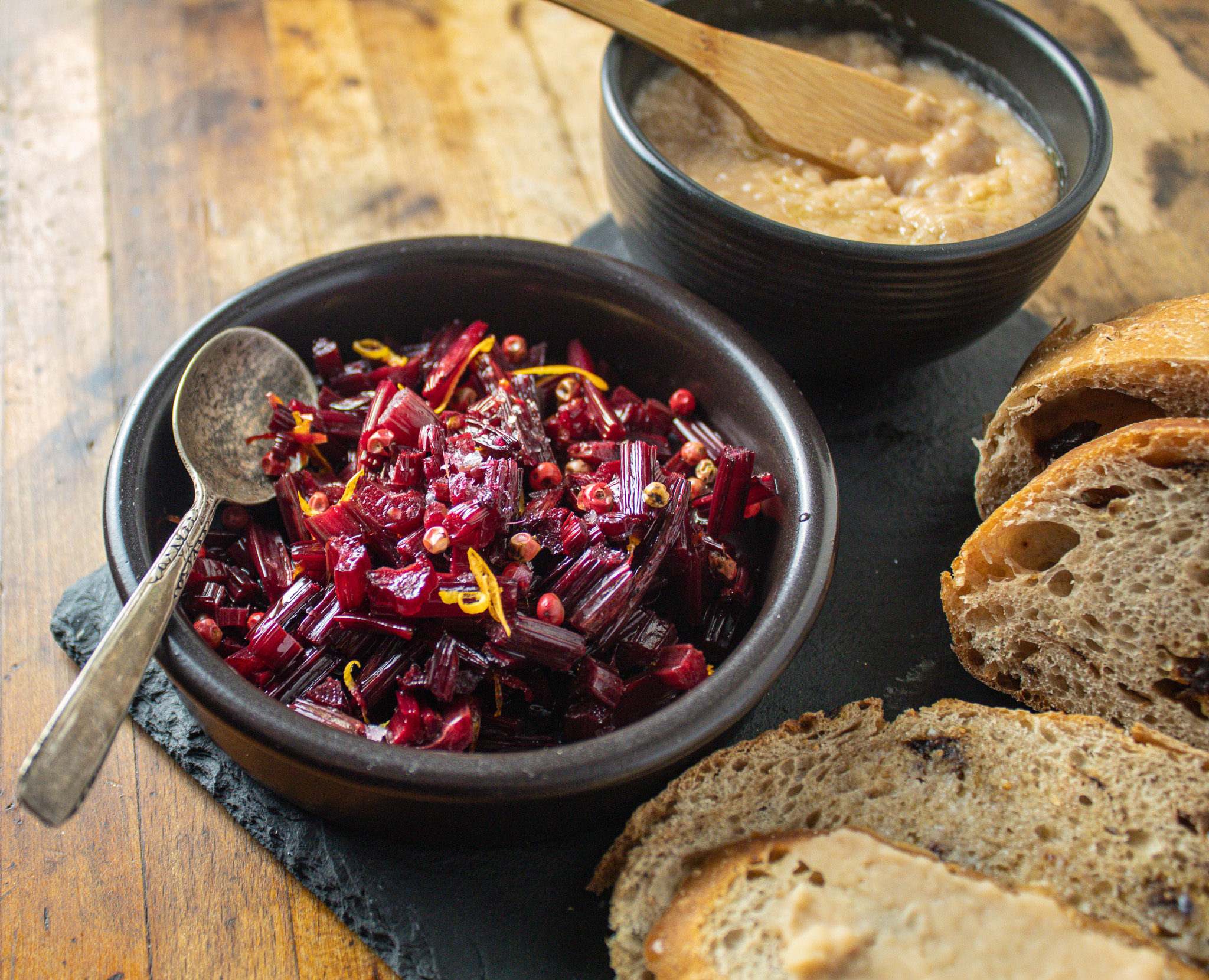 Roasted beet stalks with lemon zest, pink peppercorns, and white beans