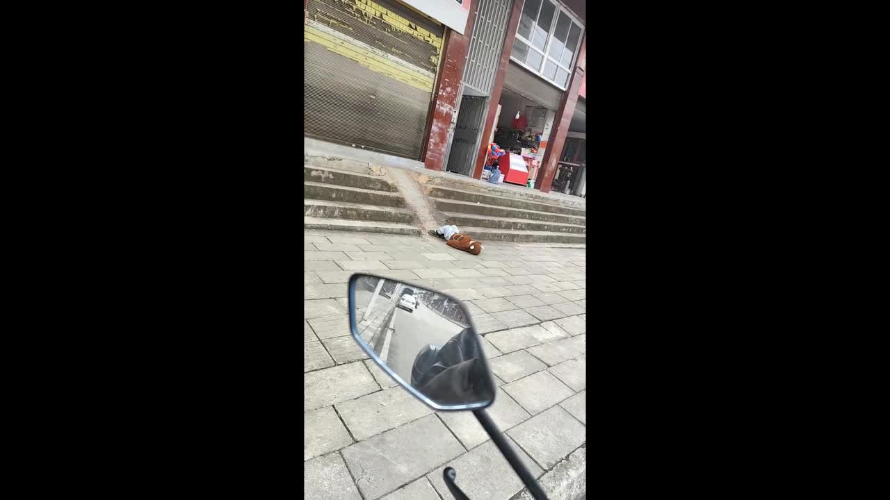 When boredom kicks in: Little boy uses pavement slope as slide