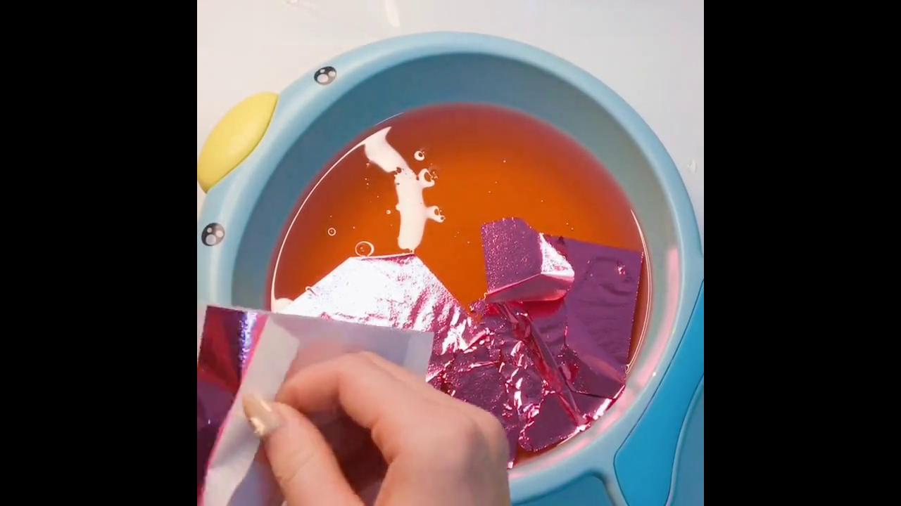Orange soft watery slime with thin foil ASMR