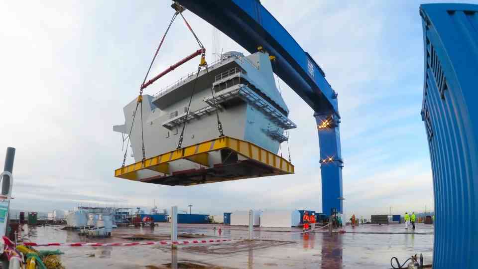 What happens during the float-out of a warship