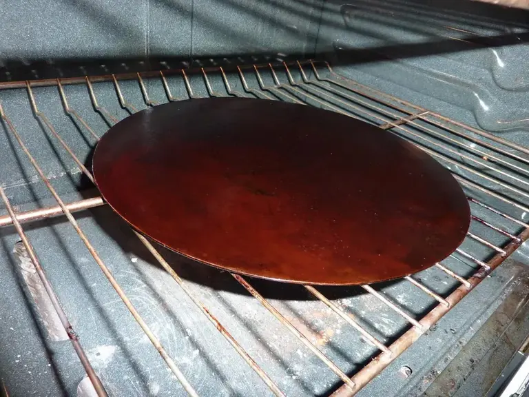 If you're still seasoning your cast iron like this, you're doing it ...