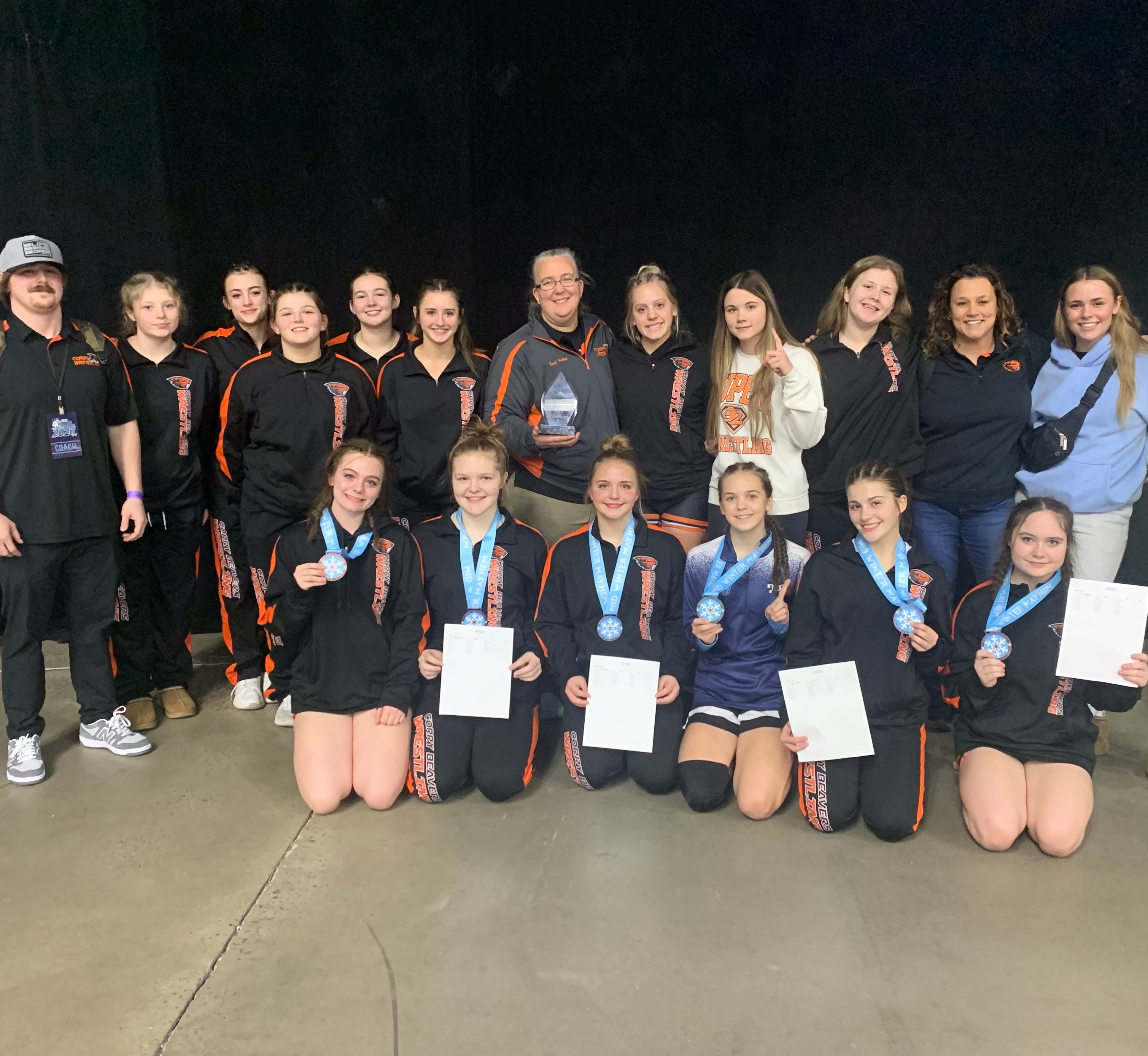 Which District 10 wrestlers medaled at Mid-Winter Mayhem?