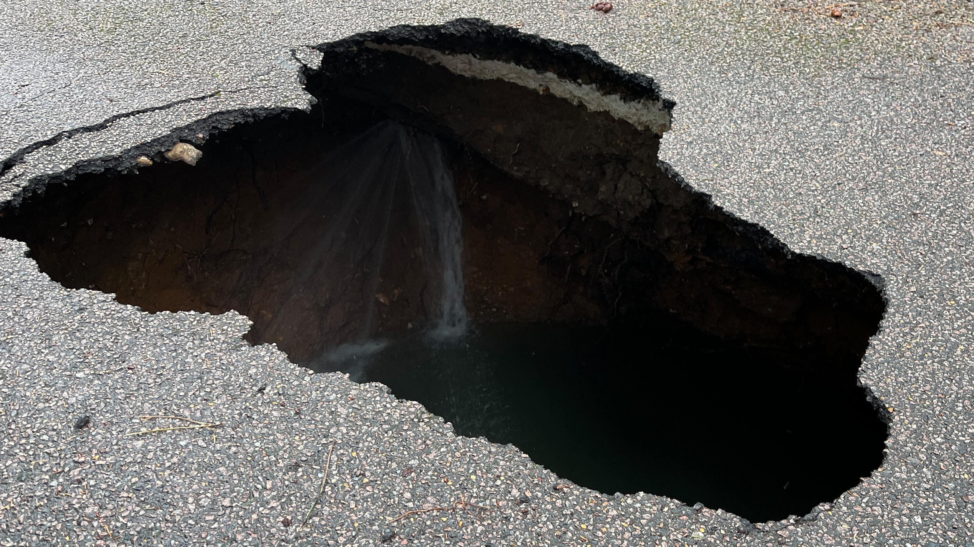Water-filled sinkhole appears on residential road