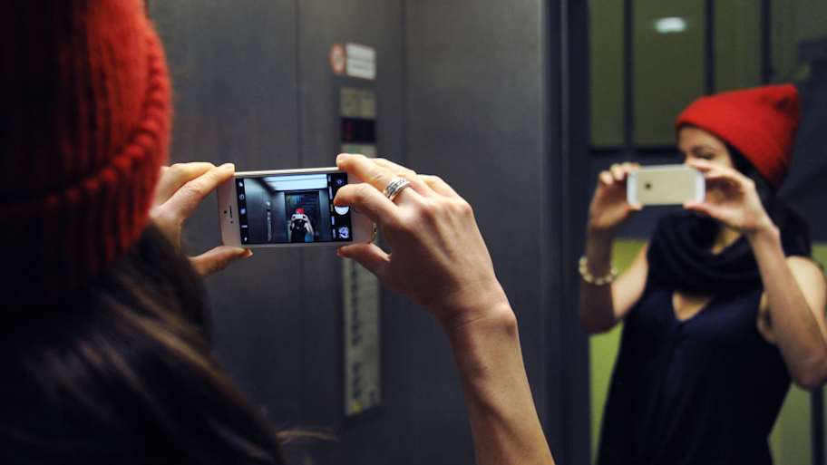 Why do elevators (almost always) have mirrors?