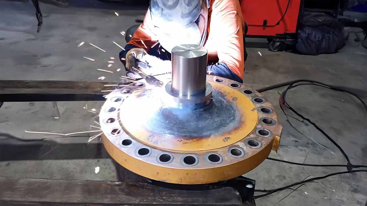 Machining and welding a dump truck suspension part