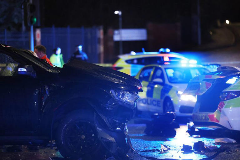 Manchester road closed after crash involving police car as it smashes ...