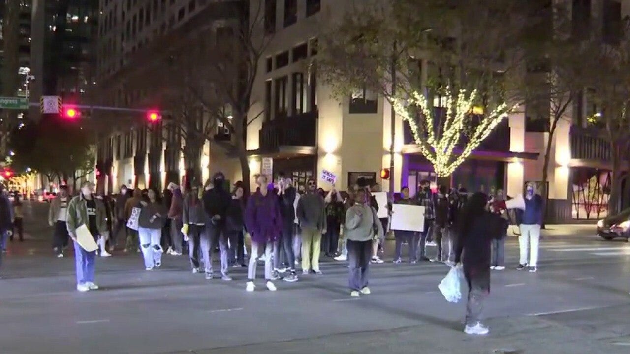 Protesters gather in front of JJ Pickle Building