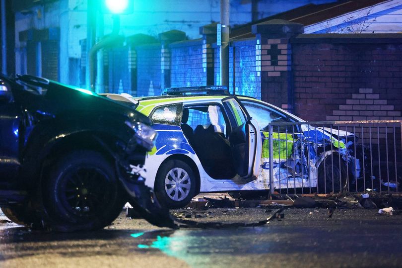 Manchester road closed after crash involving police car as it smashes ...