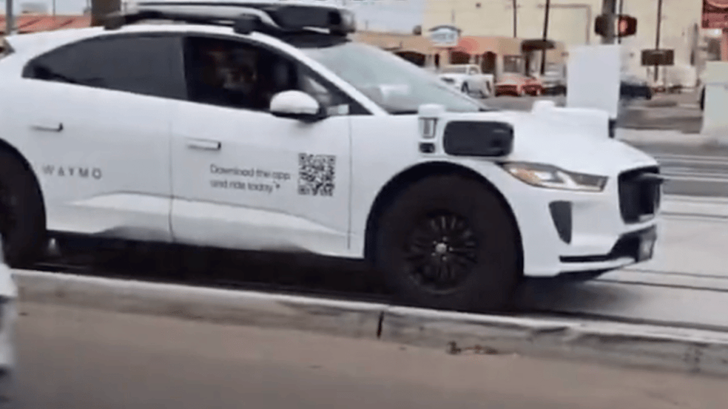 Waymo self-driving taxi drives onto train tracks as passenger jumps out ...