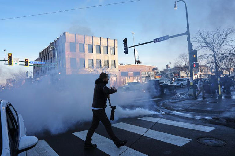 Federal agents fire tear gas at Minneapolis crowd chanting 'shame' as ...