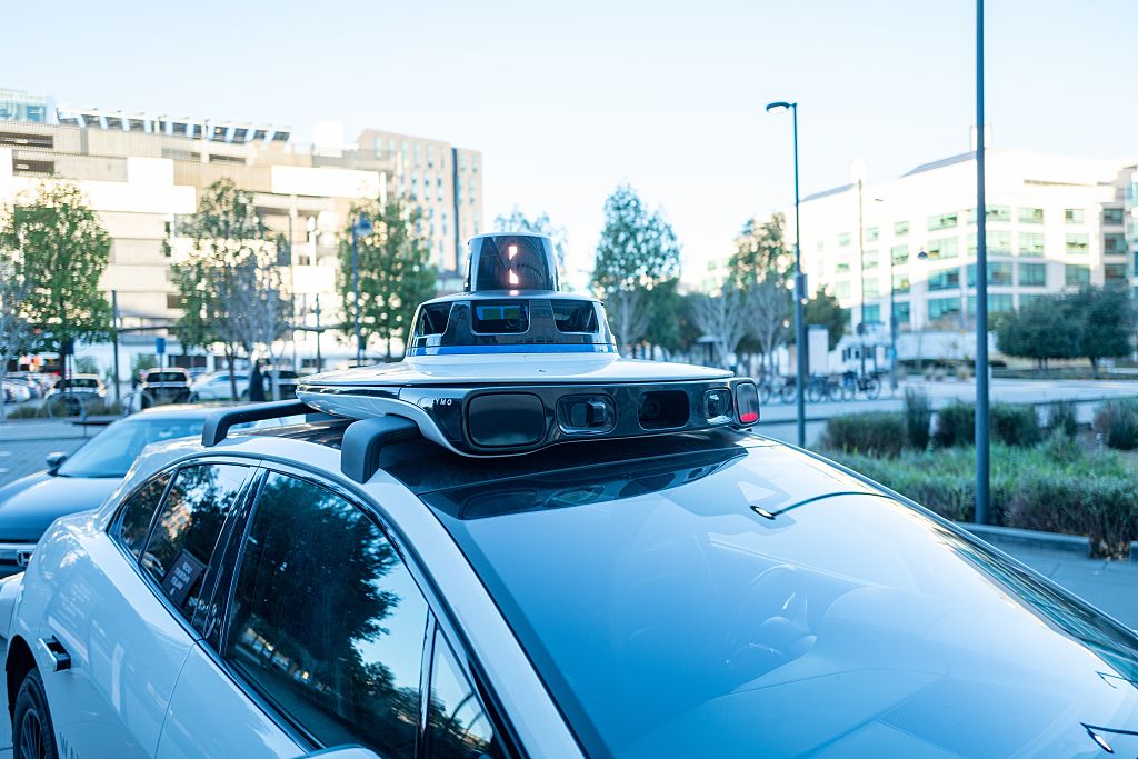 Waymo passenger jumps out after self-driving car drives onto train ...