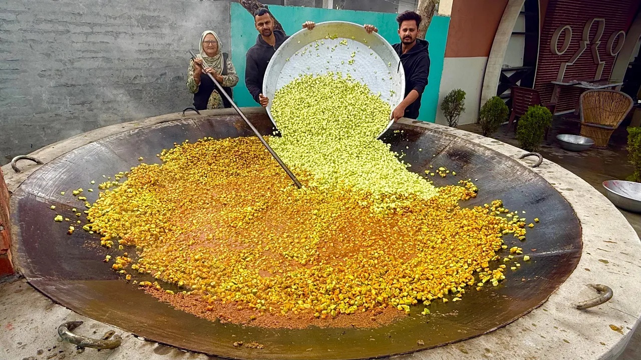 Cooking healthy green veggies in a big kadai with simple spices