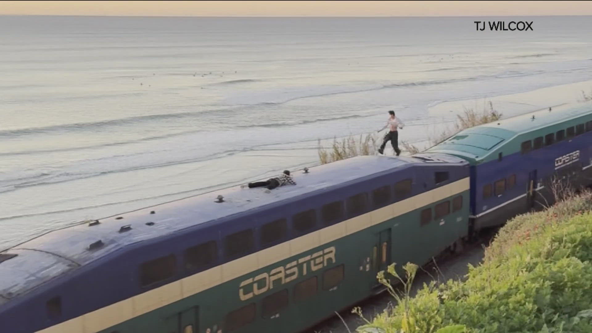Video shows 2 people on top of moving coaster train near Del Mar
