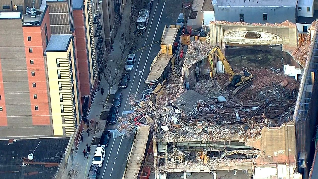 Wall partially collapses onto road during building demolition in the Bronx