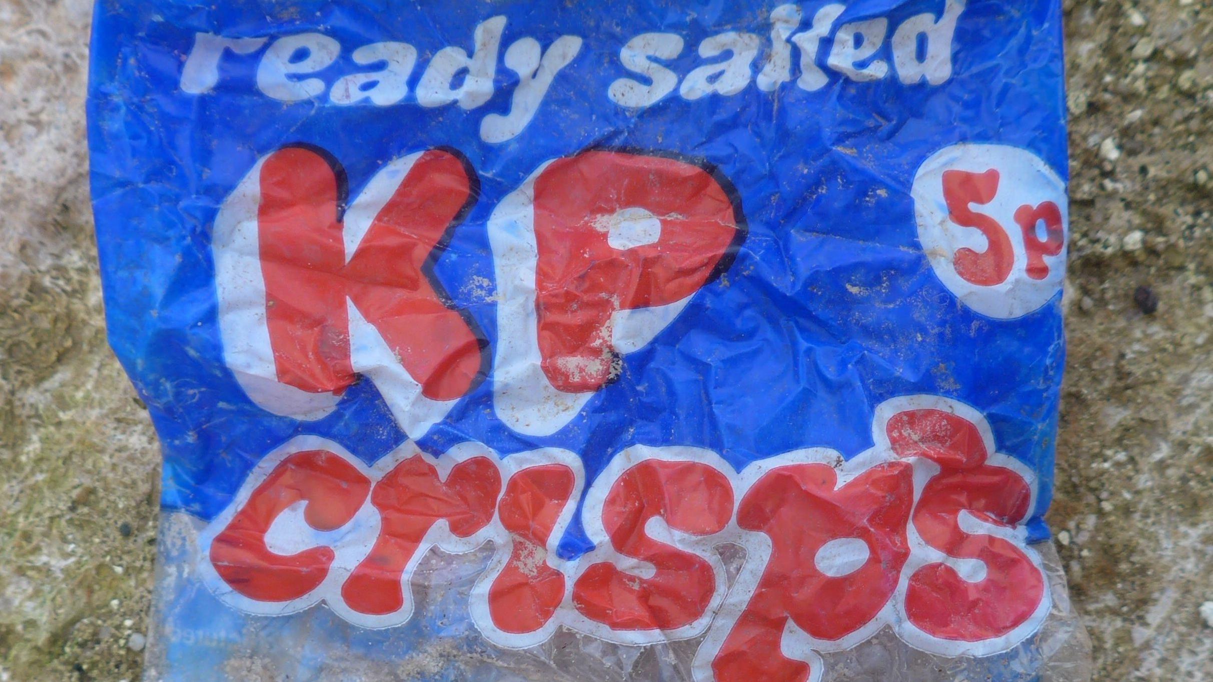 1970s crisp packet washed out of litter-filled cliff