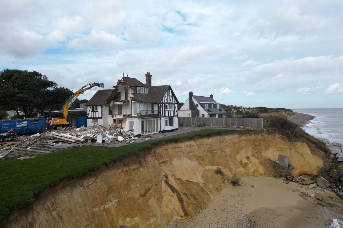 Demolition of fourth clifftop home at risk of falling into the sea begins