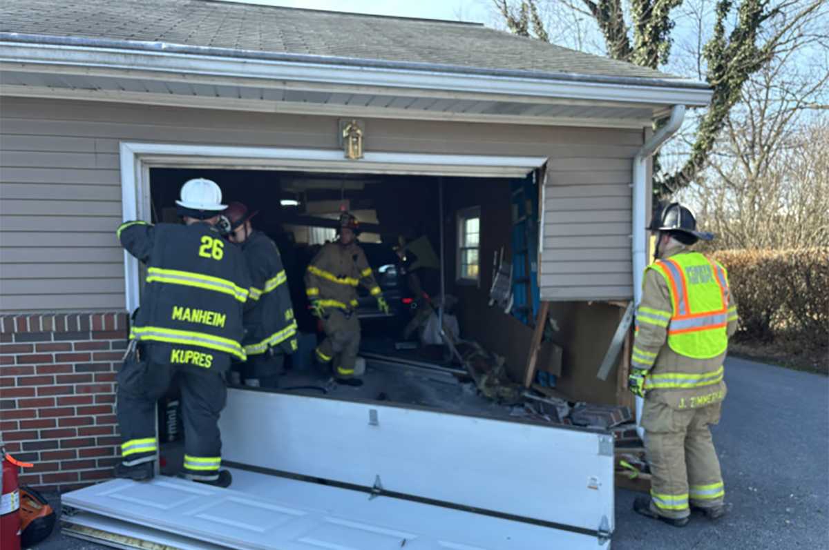 Driver moving garbage cans crashes through back of garage, police say