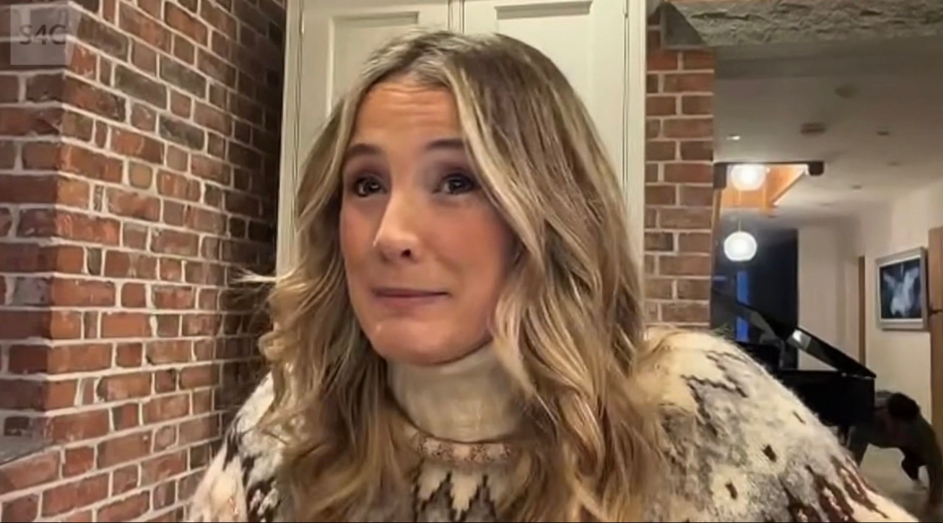 Man scuttling in background of interview is creepy