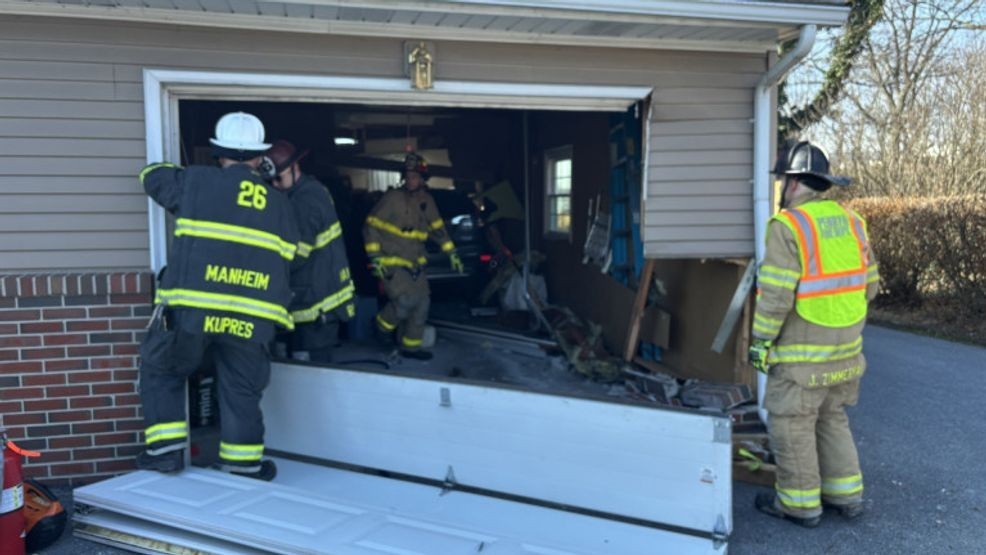 Woman rescued after accidentally driving through garage wall in ...