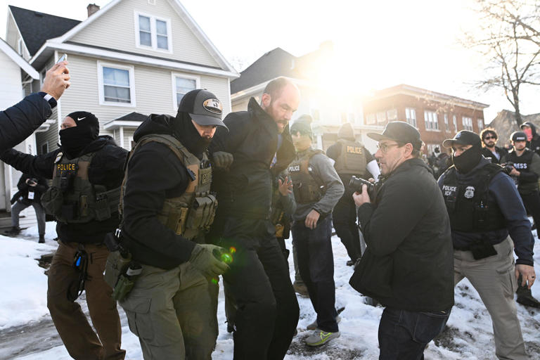 ICE officer arrested for allegedly shooting Minnesota man through front ...
