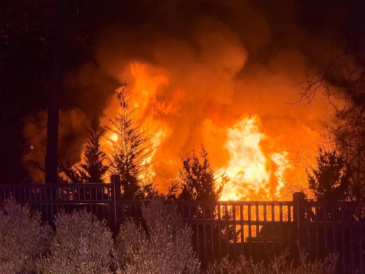 Firefighters battle fully involved garage fire with numerous small ...