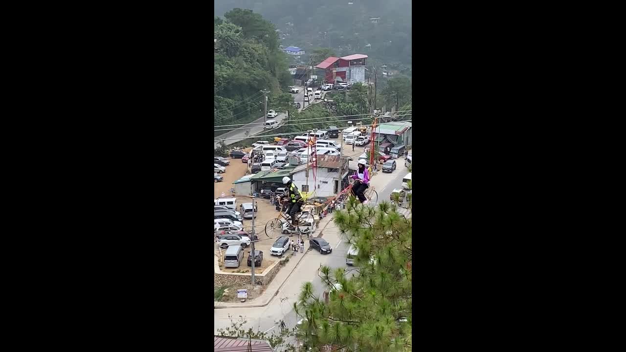 Rescuer helps girl stuck in the middle of cycling zip line
