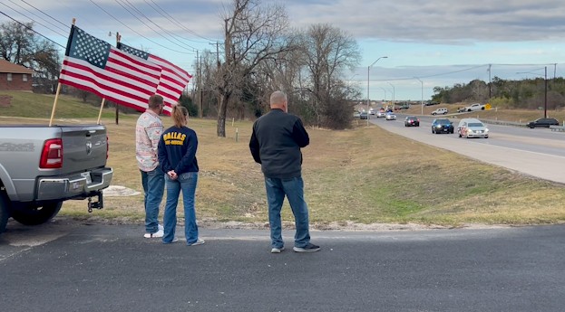 Law enforcement and community line route as officer Elijah Garretson is ...