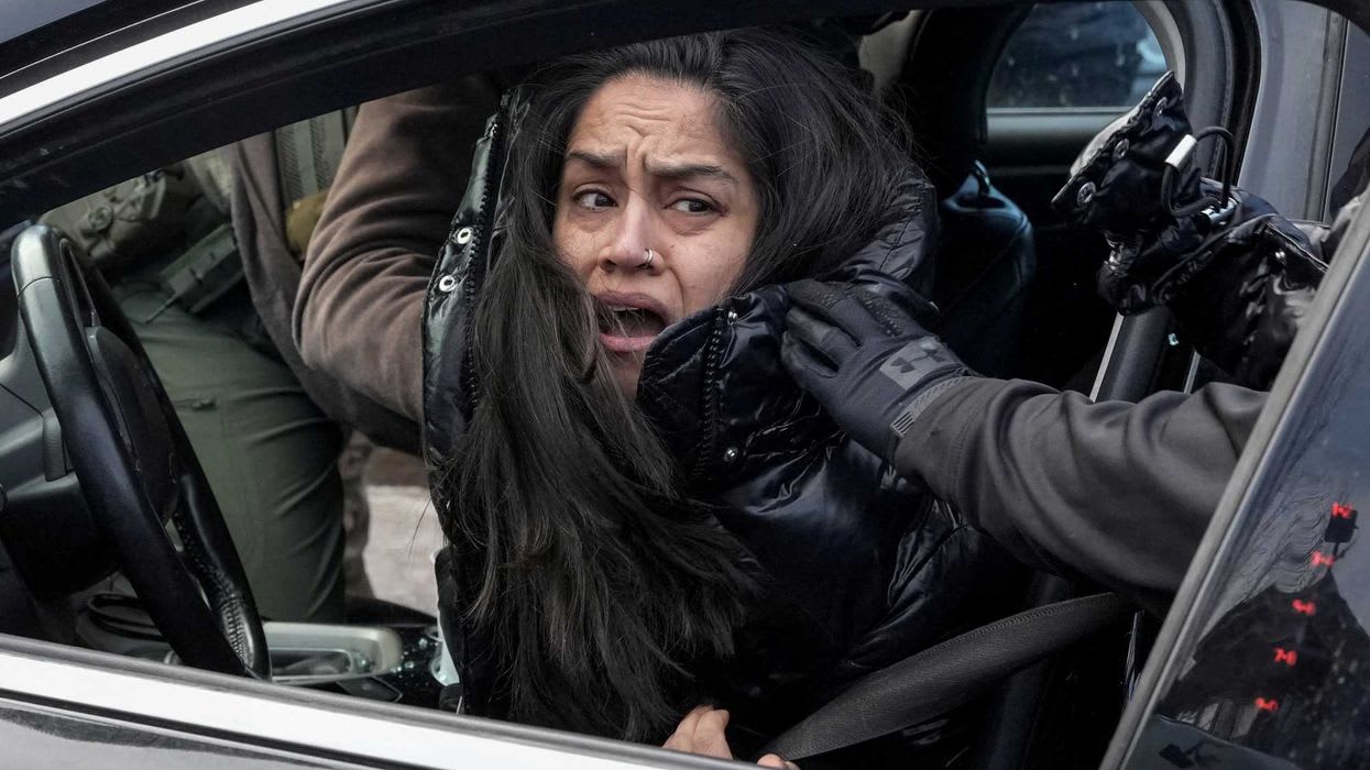 Woman screams as masked ICE agents pull her through car window