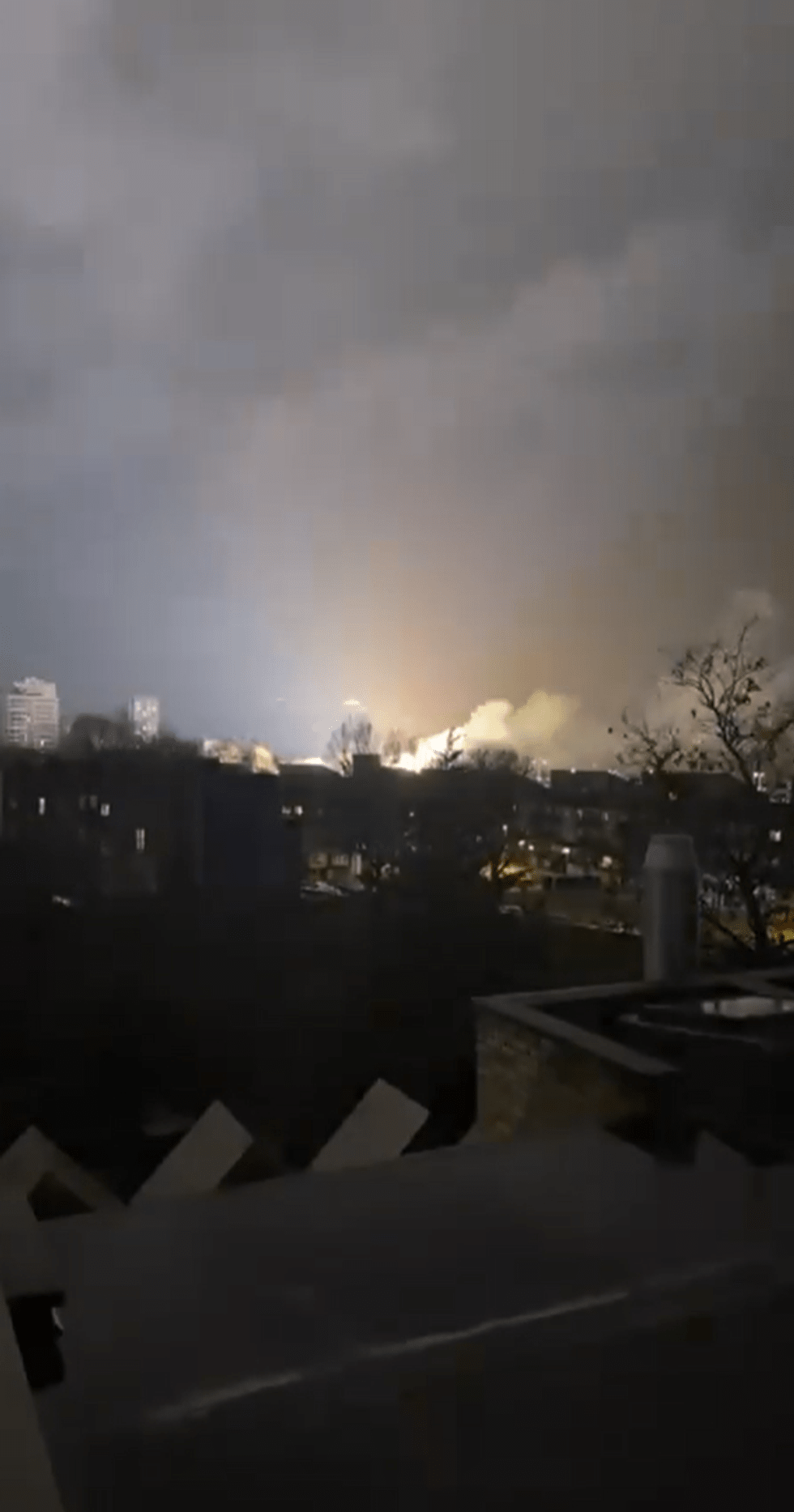 Flames erupt and black smoke fills night sky in huge blaze on train line