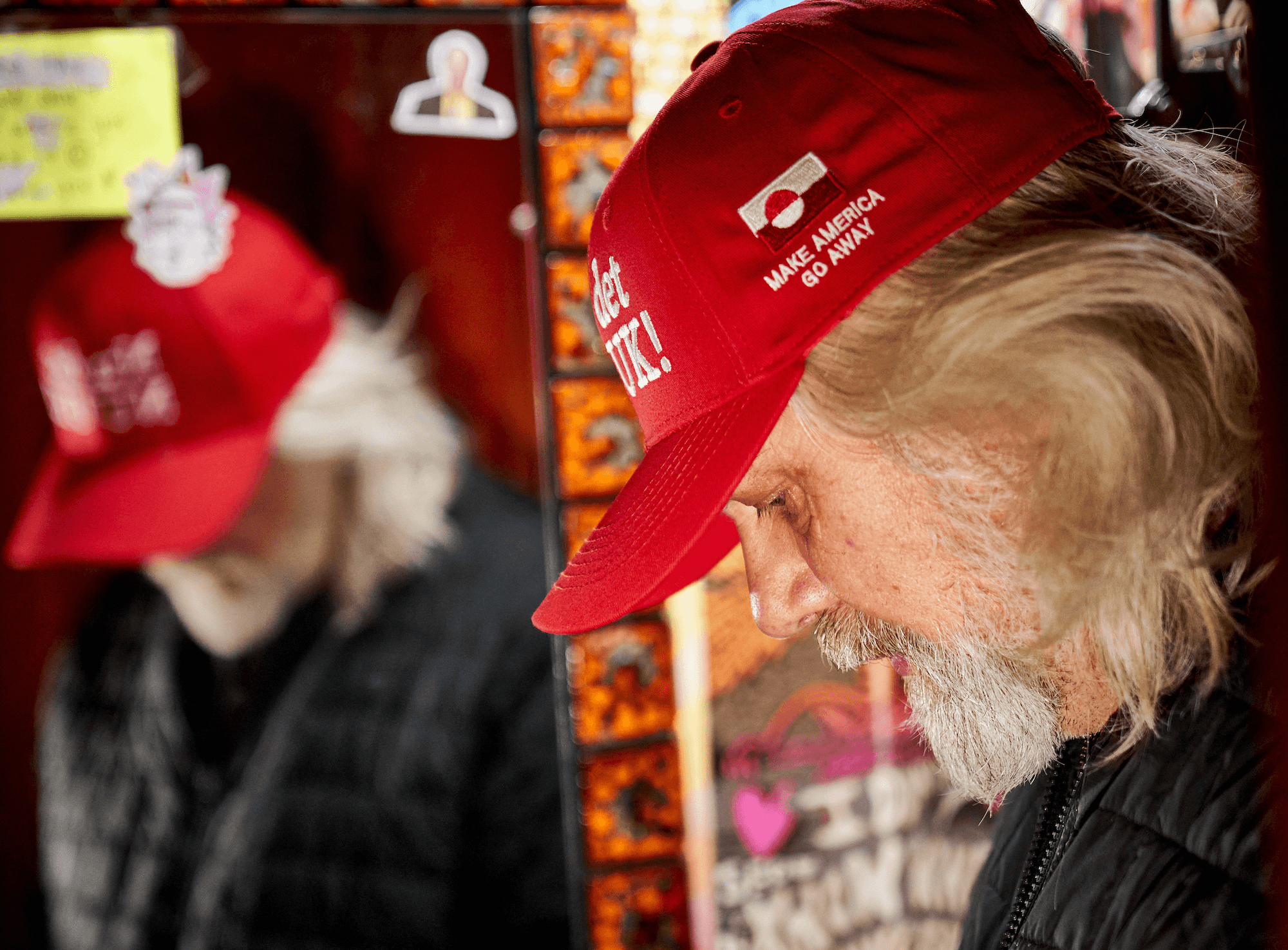 'Make America go away' protesters wear parody hats amid Trump's ...