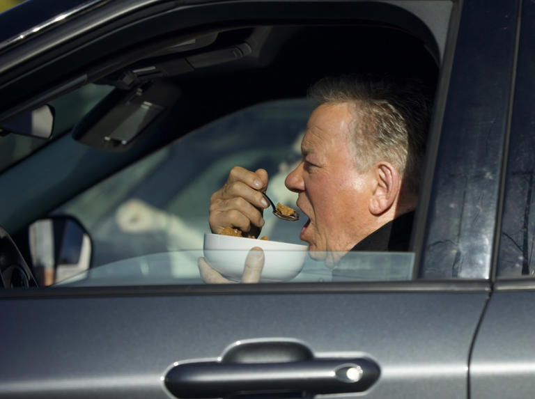 William Shatner boldly devours cereal while driving his SUV in Studio City