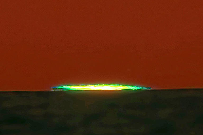 What is a 'green flash' and why does it happen?